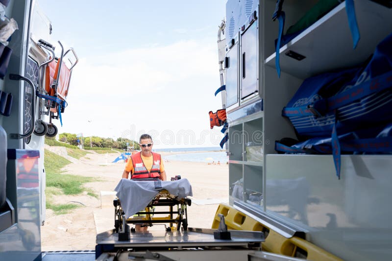First Aid Worker Using the Stretcher of Ambulance To Work Stock Photo ...