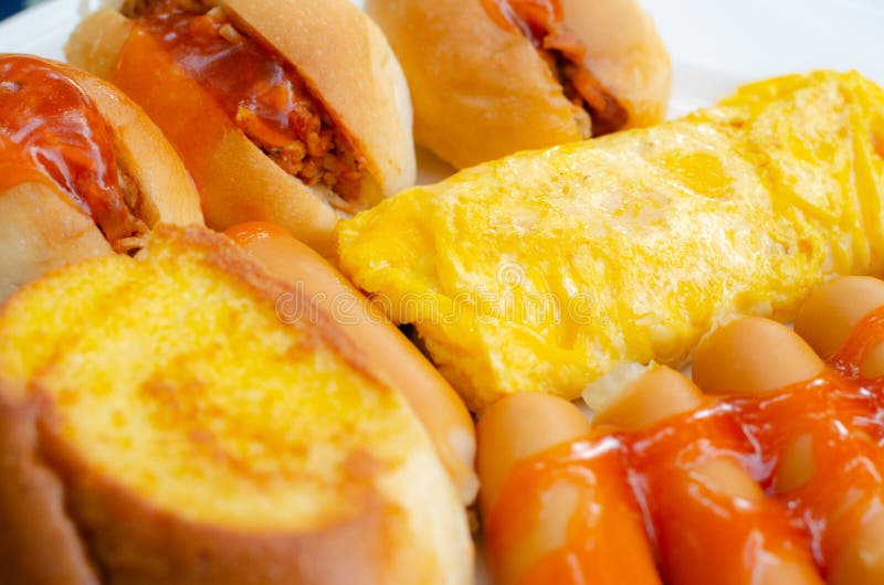 First Breakfast with Sausage, Bread,egg on White Plate in the Morning ...