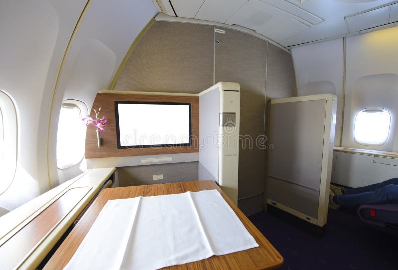 First Class Cabin with Big Table and Blank Screen Stock Photo - Image ...