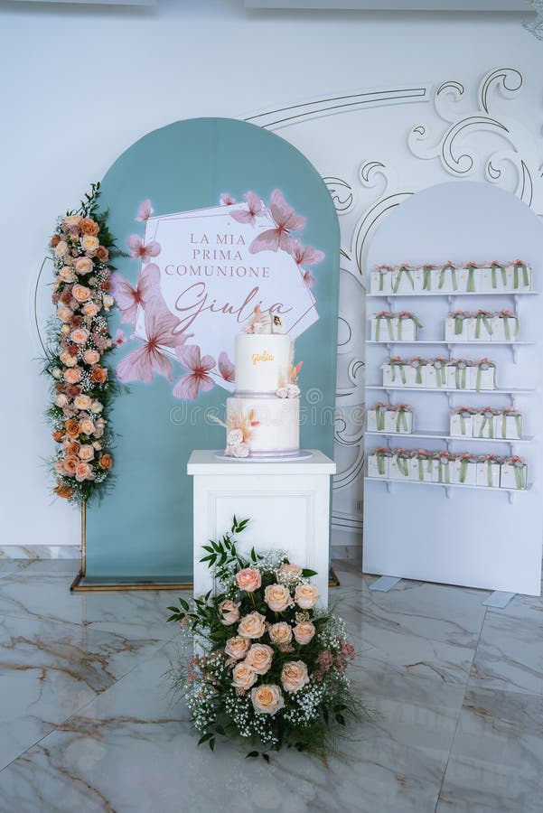 First Communion Celebration Setup with Cake and Floral Decorations ...
