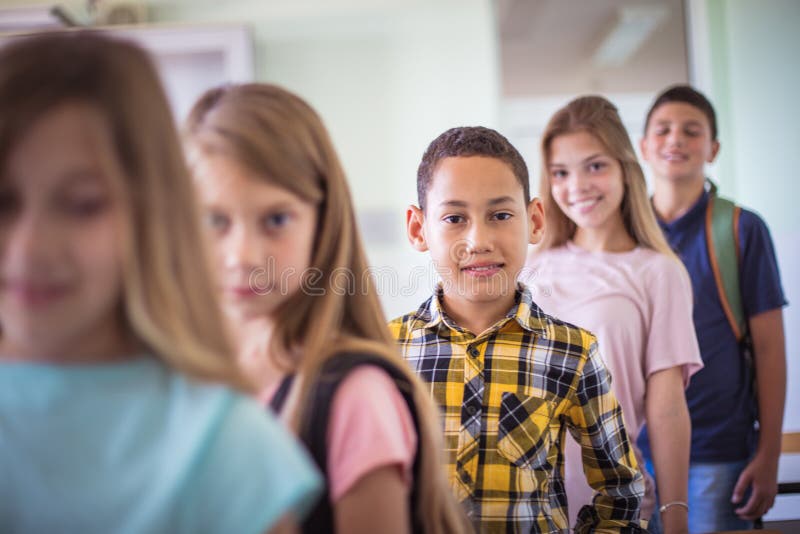 Large Group of School Children Standing in Classroom. Looking at Camera ...