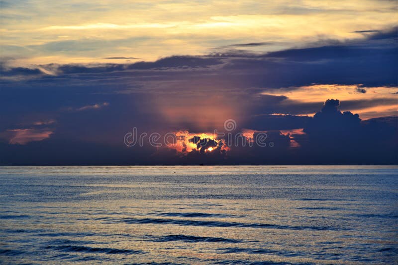 First Light Breaks through the Morning Clouds Over the Atlantic Ocean ...