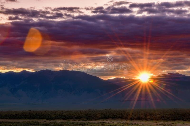 First Light of Day As a Large Sunburst Peaks Over the Edge of a ...