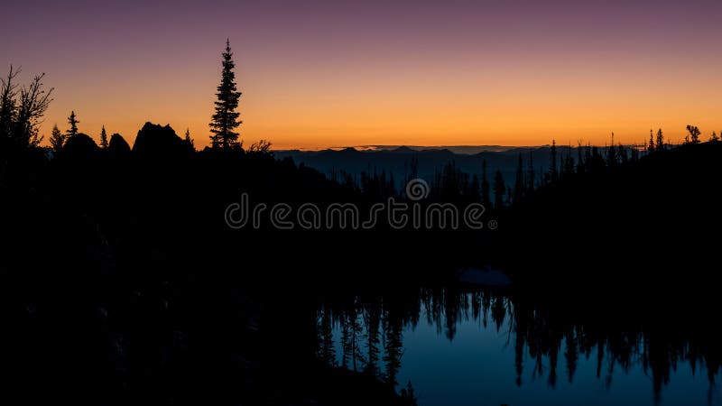 First Light of Morning Creating a Silhouette Over the Mountains Stock ...