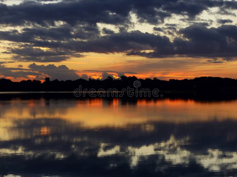 First light sunrise stock image. Image of still, clouds - 68763963