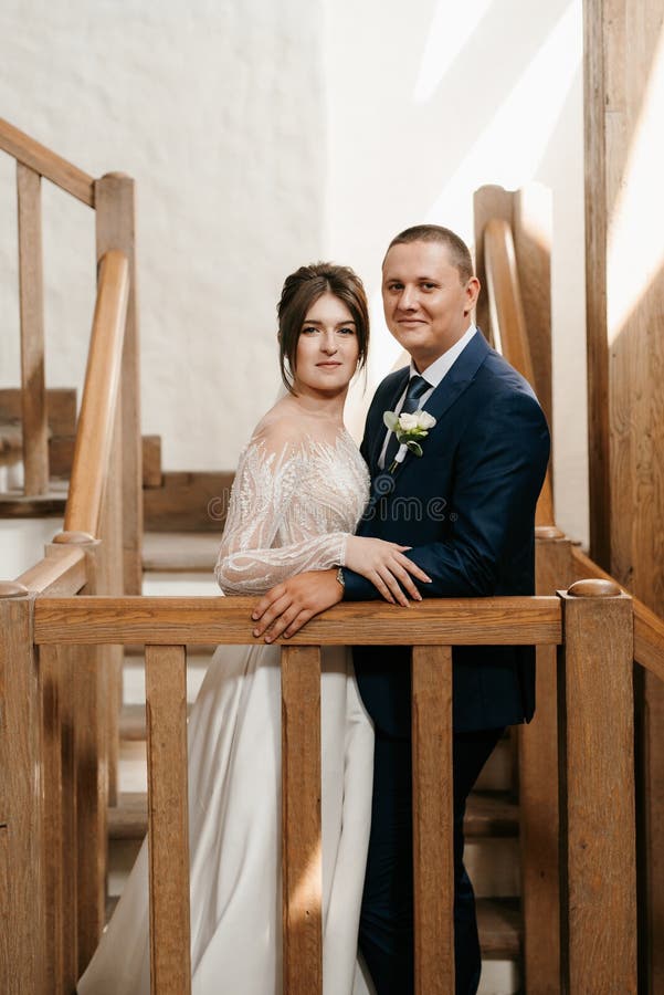 The First Meeting of the Bride and Groom on a Wooden Staircase Stock ...