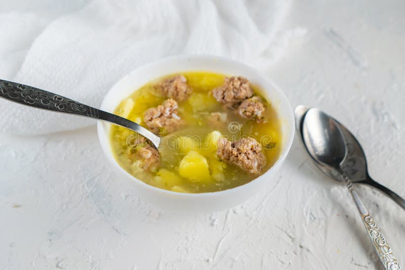 First Person View of a Person Eat Steaming Soup with Meatballs Using a ...