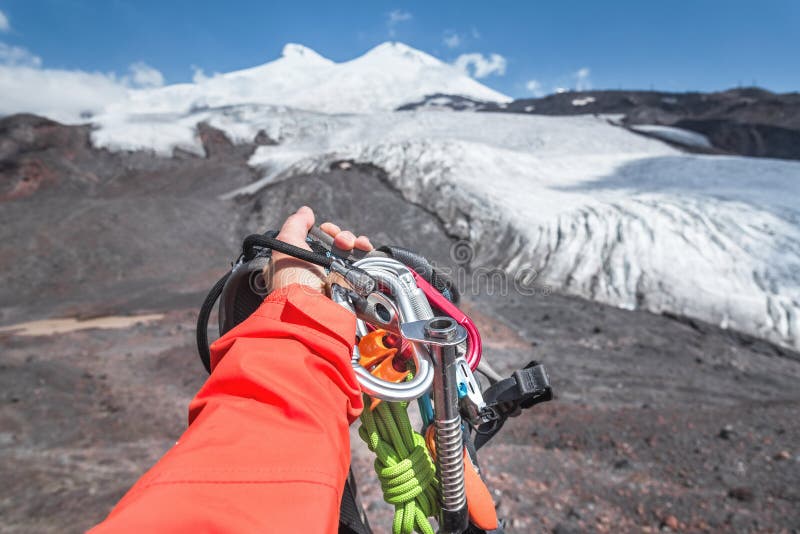 First-person View of a Hand with Climbing Equipment High in the ...