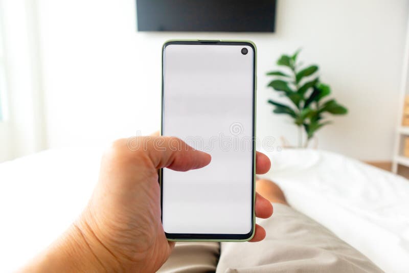 First Person View of Man Using Smartphone while on the Bed. Stock Image ...