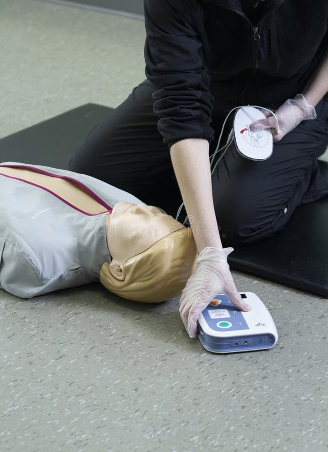 First Response Worker Demonstrates CPR and Proper Defibrillator ...