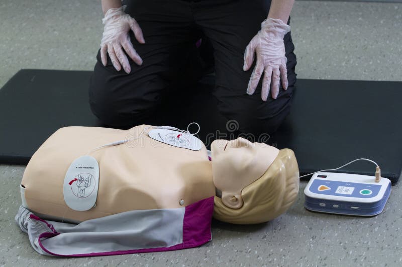First Response Worker Demonstrates CPR and Proper Defibrillator ...