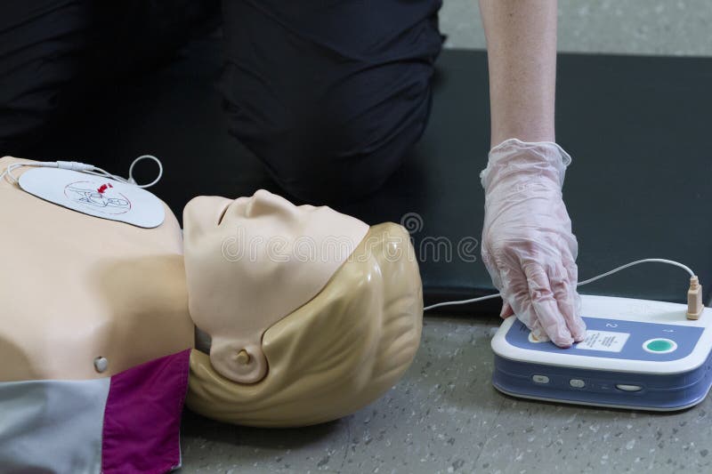 First Response Worker Demonstrates CPR and Proper Defibrillator ...