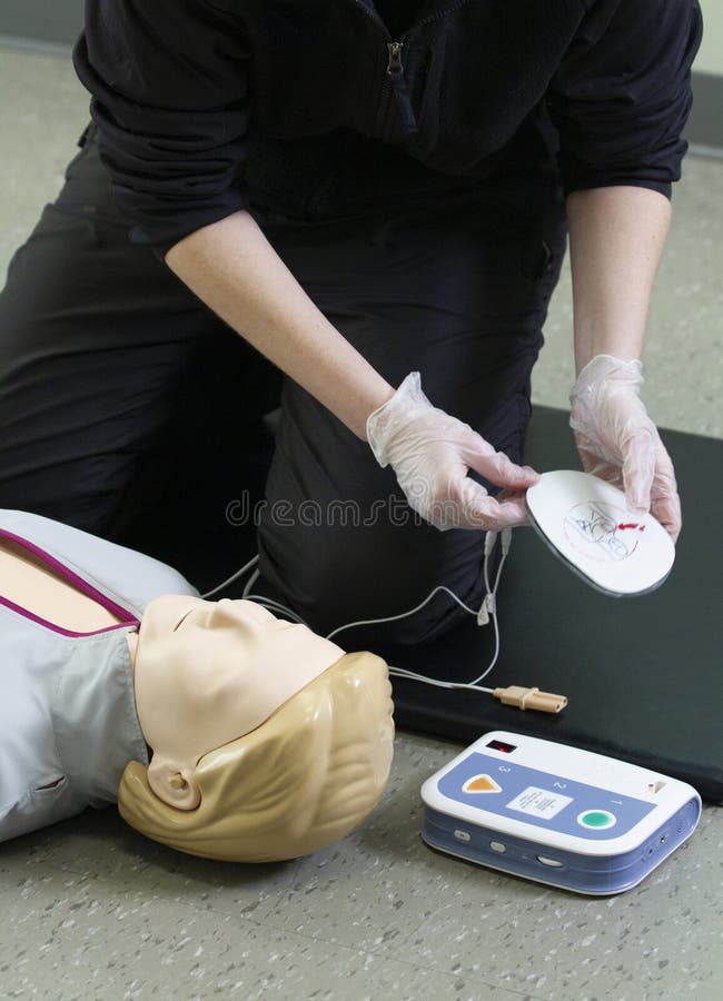 First Response Worker Demonstrates CPR and Proper Defibrillator ...