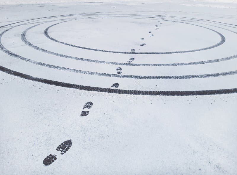 First Snow. an Imprint of the Wheels of a Car in a Circle and a Man ...