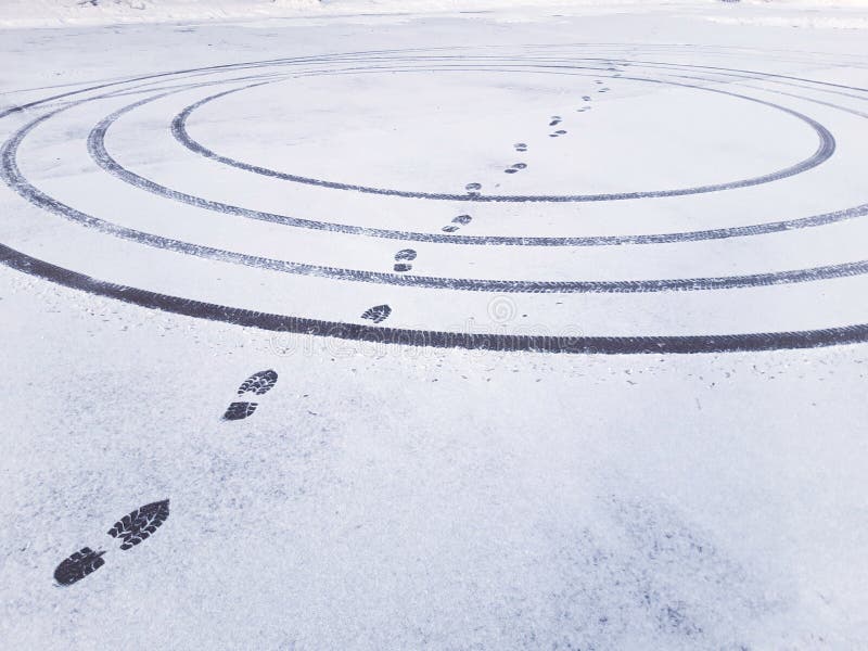 First Snow. an Imprint of the Wheels of a Car in a Circle and a Man ...