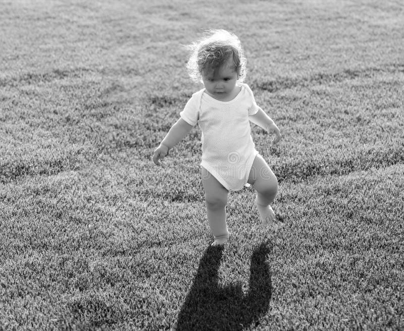 First Step. Baby Bare Legs Standing on Green Grass. Stock Photo - Image ...