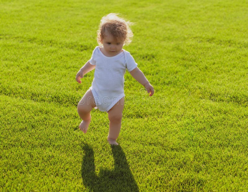 First Step. Baby Bare Legs Standing on Green Grass. Stock Photo - Image ...