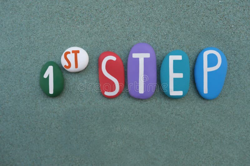 First Step Composed with Multi Colored Stone Letters Over Green Sand ...