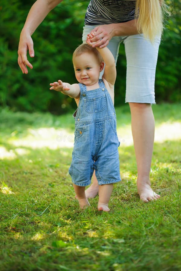 Cute Little Baby Girl on Walk with Parents, First Steps Stock Photo ...