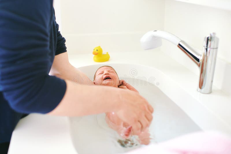 The First Time Bath for Newborn Baby Stock Photo - Image of child, hand ...