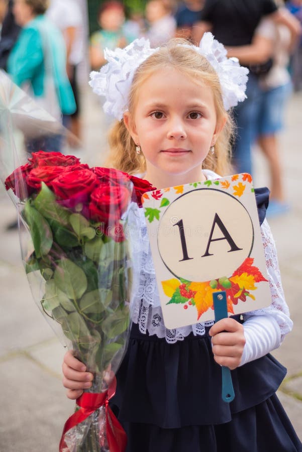 A First-grader Girl in a Beautiful Elegant Modern School Uniform on the ...