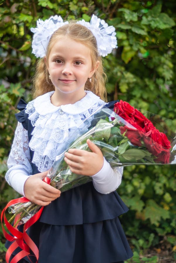 A First-grader Girl in a Beautiful Elegant Modern School Uniform on the ...