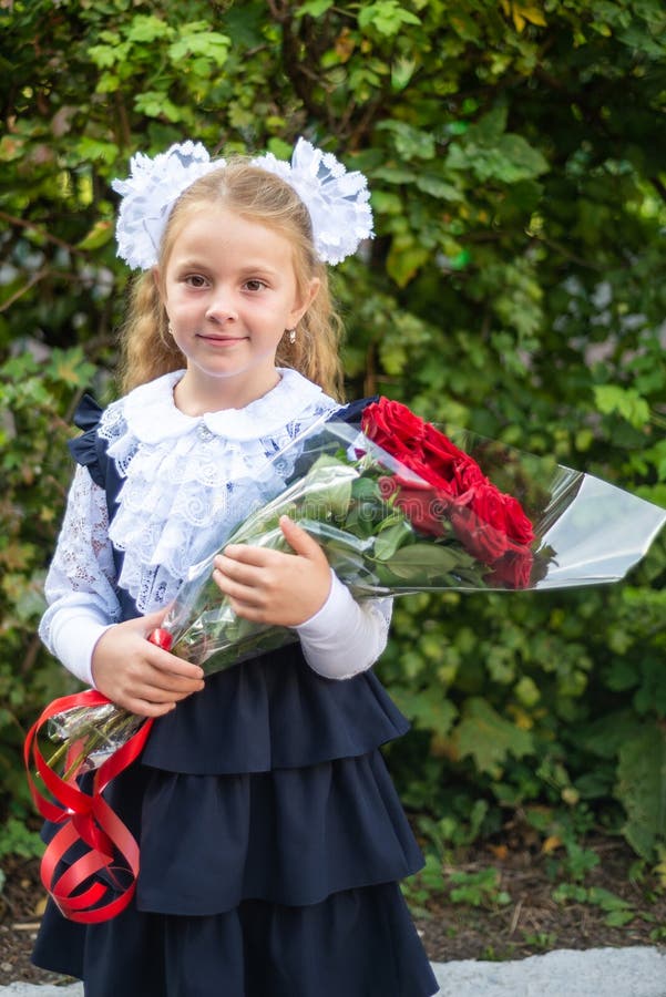 A First-grader Girl in a Beautiful Elegant Modern School Uniform on the ...