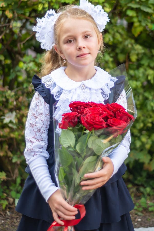 A First-grader Girl in a Beautiful Elegant Modern School Uniform on the ...