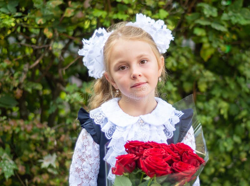 A First-grader Girl in a Beautiful Elegant Modern School Uniform on the ...