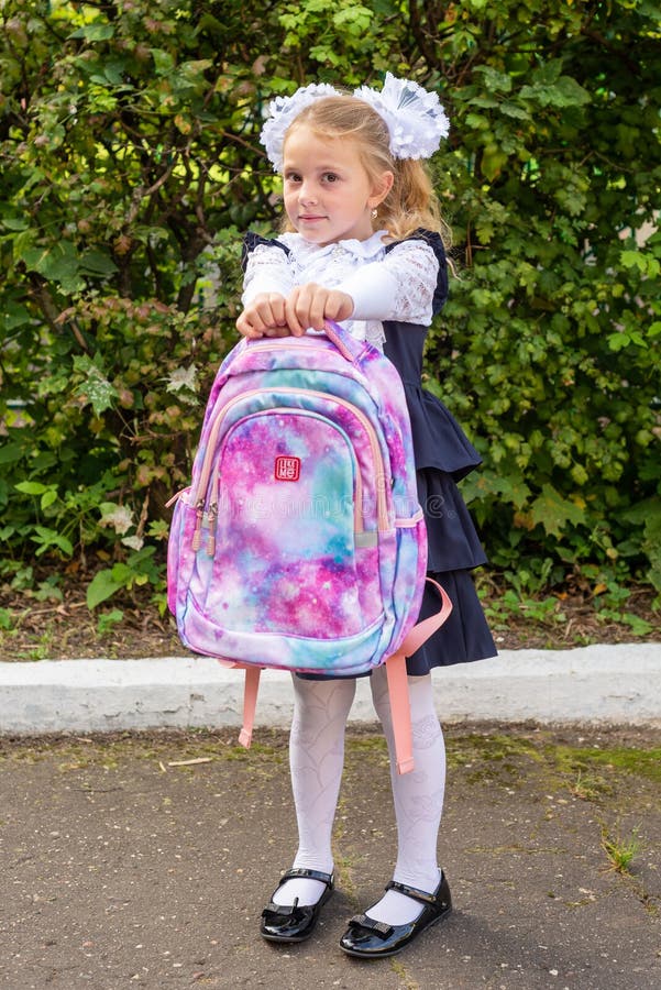 A First-grader Girl in a Beautiful Elegant Modern School Uniform on the ...