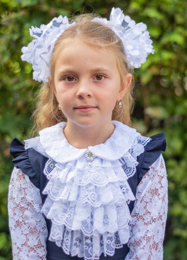 A First-grader Girl in a Beautiful Elegant Modern School Uniform on the ...