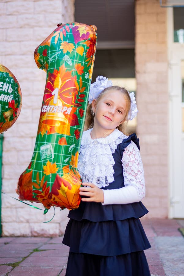 A First-grader Girl in a Beautiful Elegant Modern School Uniform on the ...