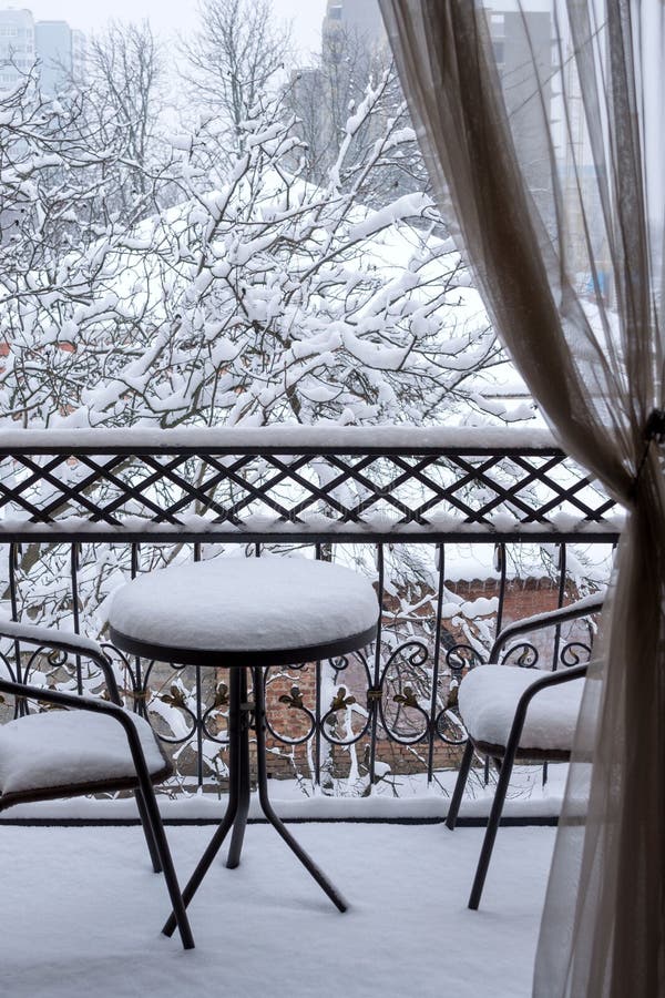 The First White Fluffy Snow on the Table and Chairs on the Wrought-iron ...