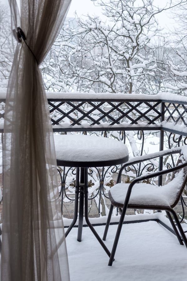 The First White Fluffy Snow on the Table and Chairs on the Wrought-iron ...