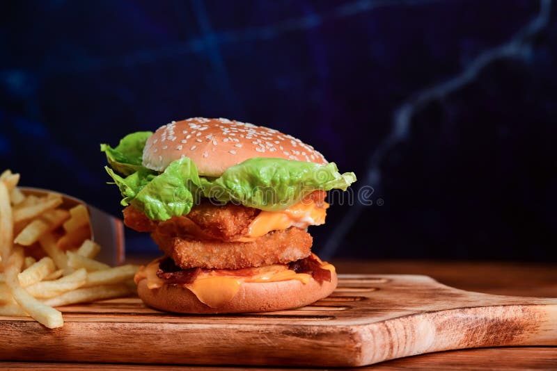 Fish Burger with Fresh Vegetables and Cheese on Wooden Table. Stock ...