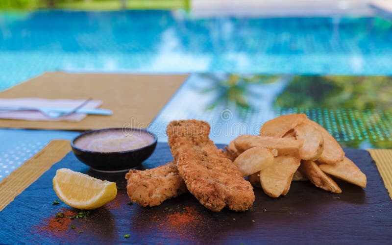 Fish and Chips on a Plate Isolated by the Pool Stock Image - Image of ...