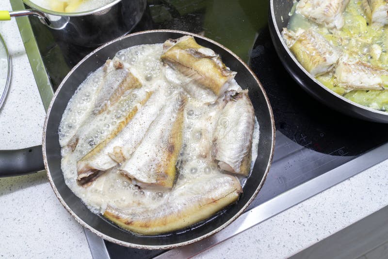 Fish is Cooked in Two Pans on an Electric Stove Stock Image - Image of ...