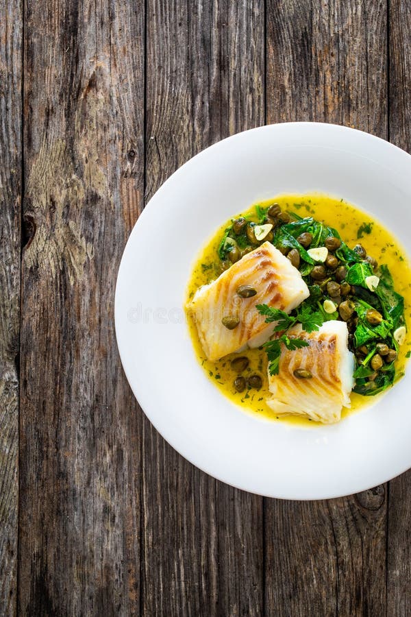 Fish Dish Fried Cod Spinach Capers Saffron Sauce Wooden Table Stock ...