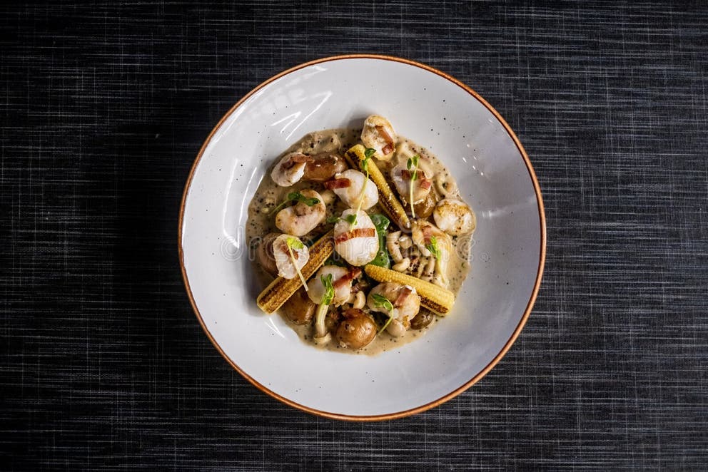 A Fish Dish in a White Plate with Baby Corn and Cress. Stock Photo ...