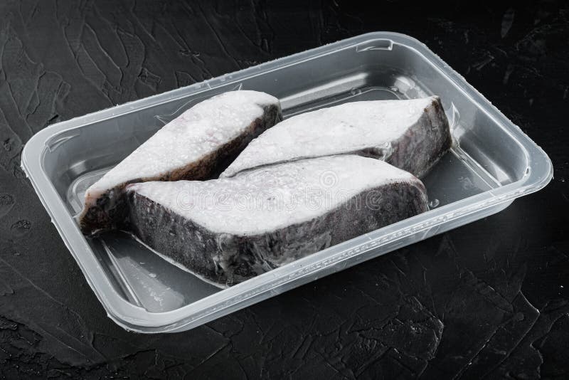 Fish Fillet Frozen Pack, on Black Dark Stone Table Background Stock ...