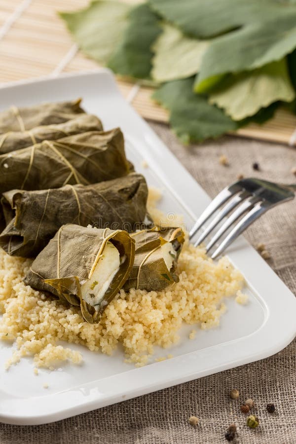 Fish fillet in grape leafs stock image. Image of fork - 47629473