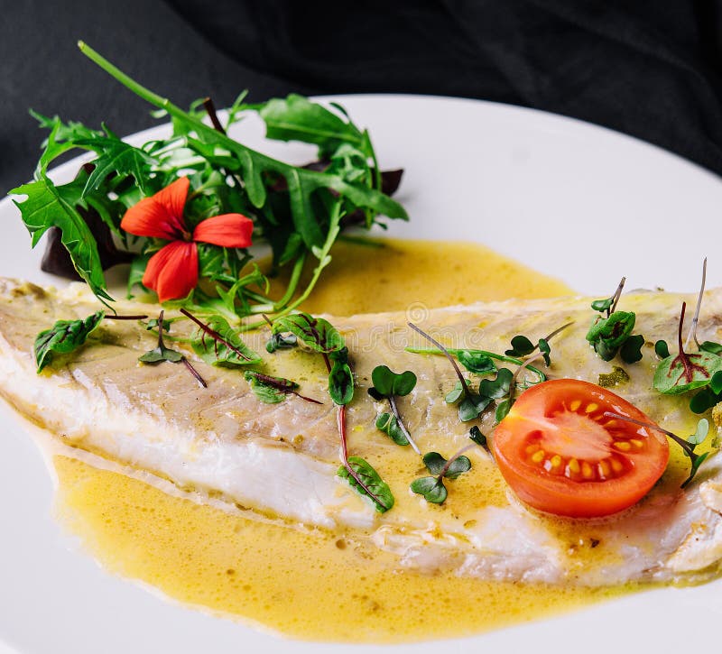 Fish Fillet in White Sauce on White Plate Stock Photo - Image of ...