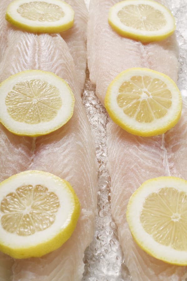 Fish fillets and lemon stock image. Image of 980590, fruit - 7676145