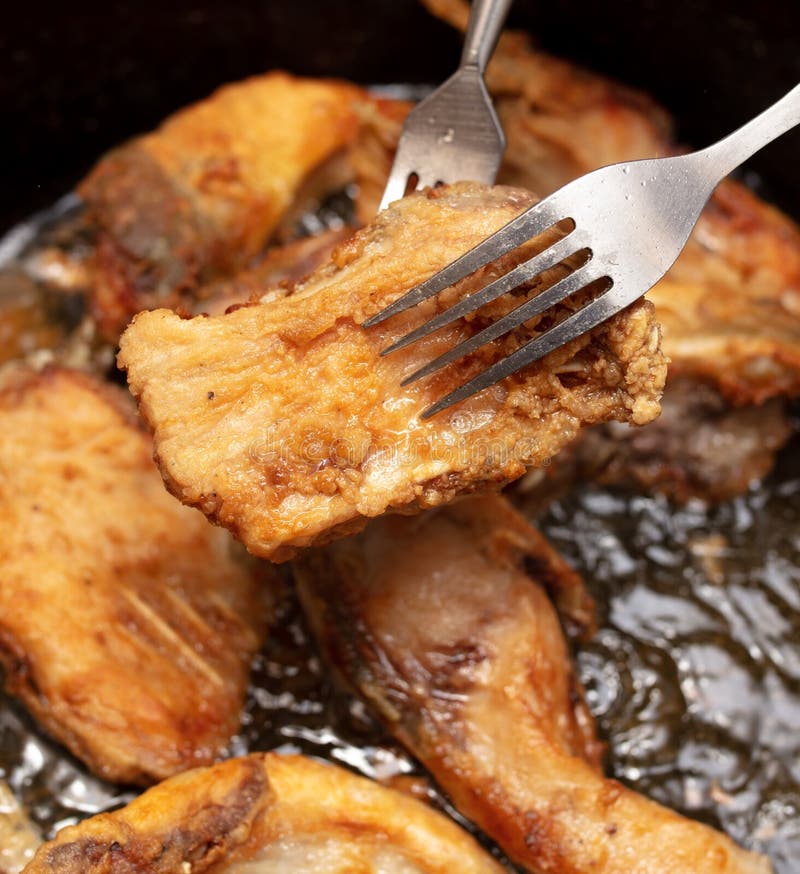 The fish is fried in oil stock photo. Image of seafood - 213130936