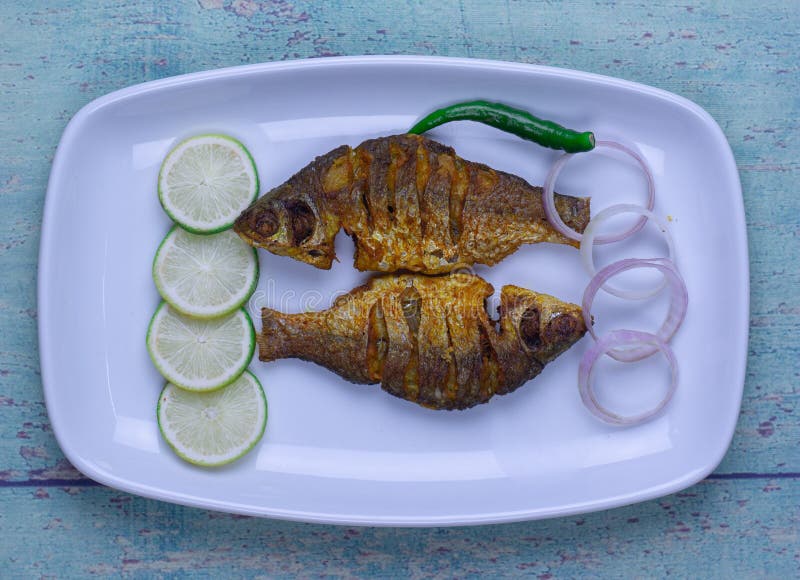 Fish Fry with Onion Slice, Lemon Slice and Chilli Stock Image - Image ...