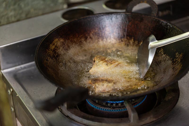 Fish Frying in Oil on the Fire Stock Photo - Image of iron, hand: 168632474