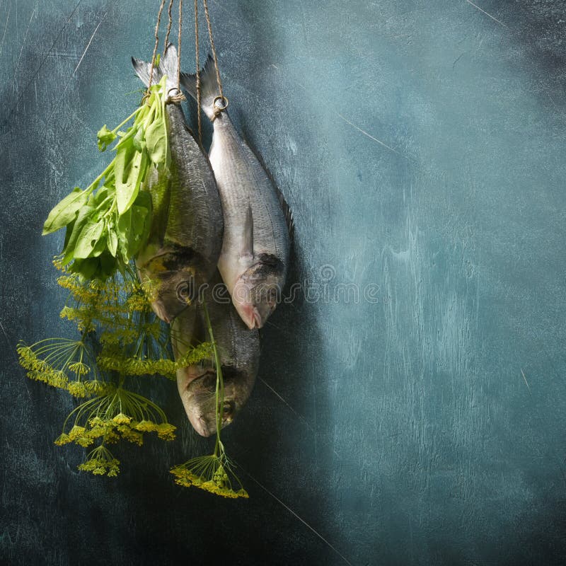 Fish Hanging on the Background of an Old Painted Blue Wall. Stock Photo ...