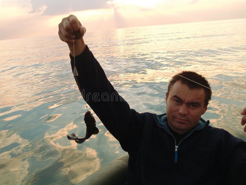 Fish on hook stock photo. Image of clouds, fish, person - 782178