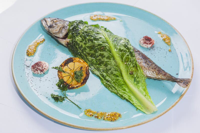 Fish with Lettuce on the Turquoise Plate Stock Photo - Image of ...
