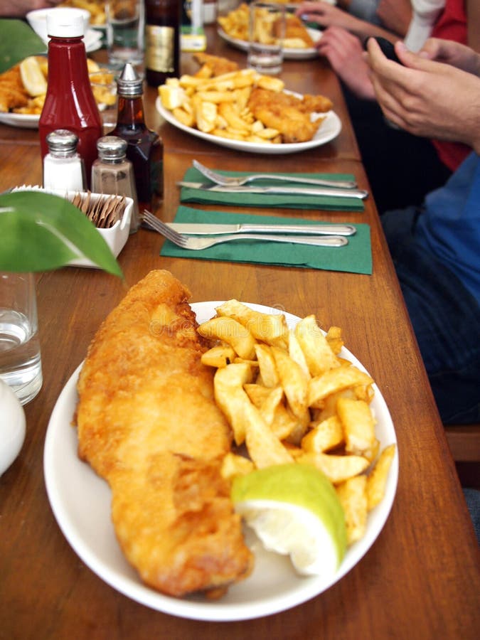 Fish n chips on table stock image. Image of dining, plates - 23805693